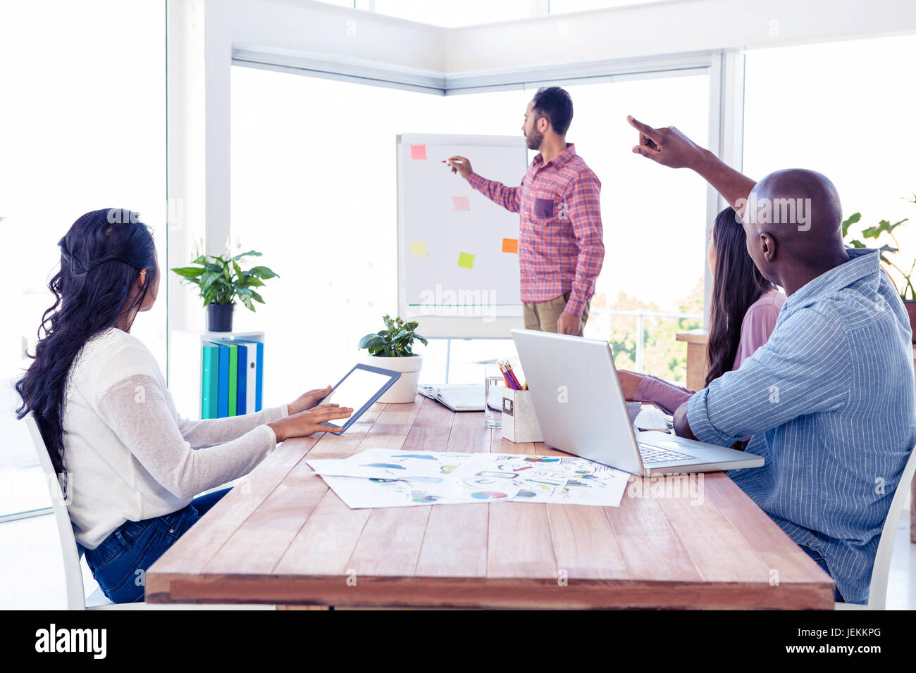 Businessman giving presentation to colleagues Stock Photo - Alamy