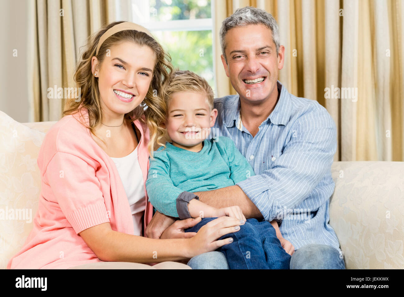 Happy family sitting together Stock Photo - Alamy