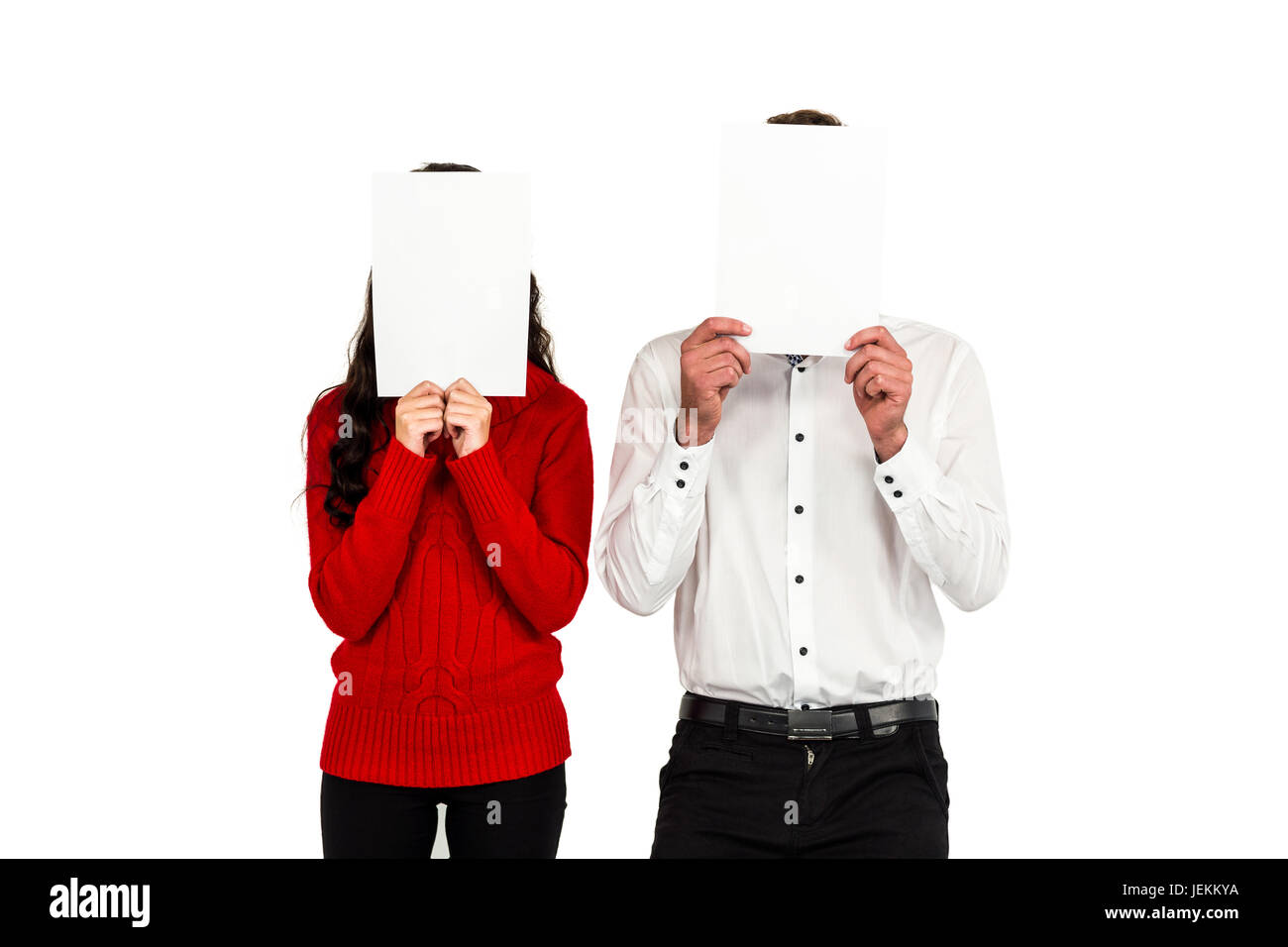 Couple covering their faces with documents Stock Photo - Alamy