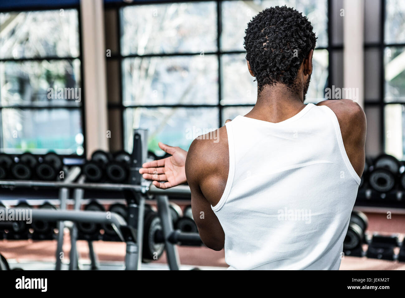 Rear view of man stretching arms Stock Photo - Alamy