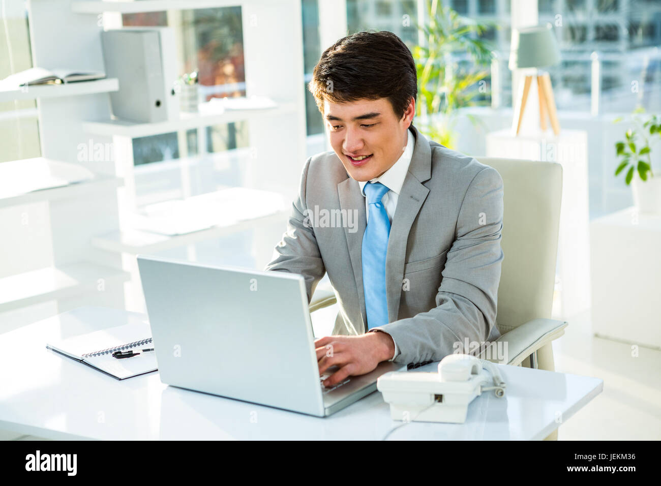 Asian businessman using his computer Stock Photo - Alamy