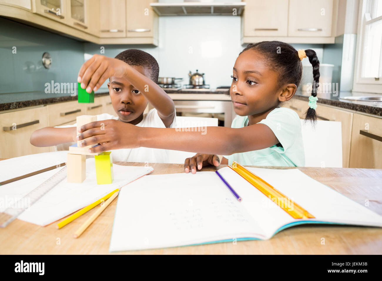Children doing homework in the kitchen Stock Photo - Alamy