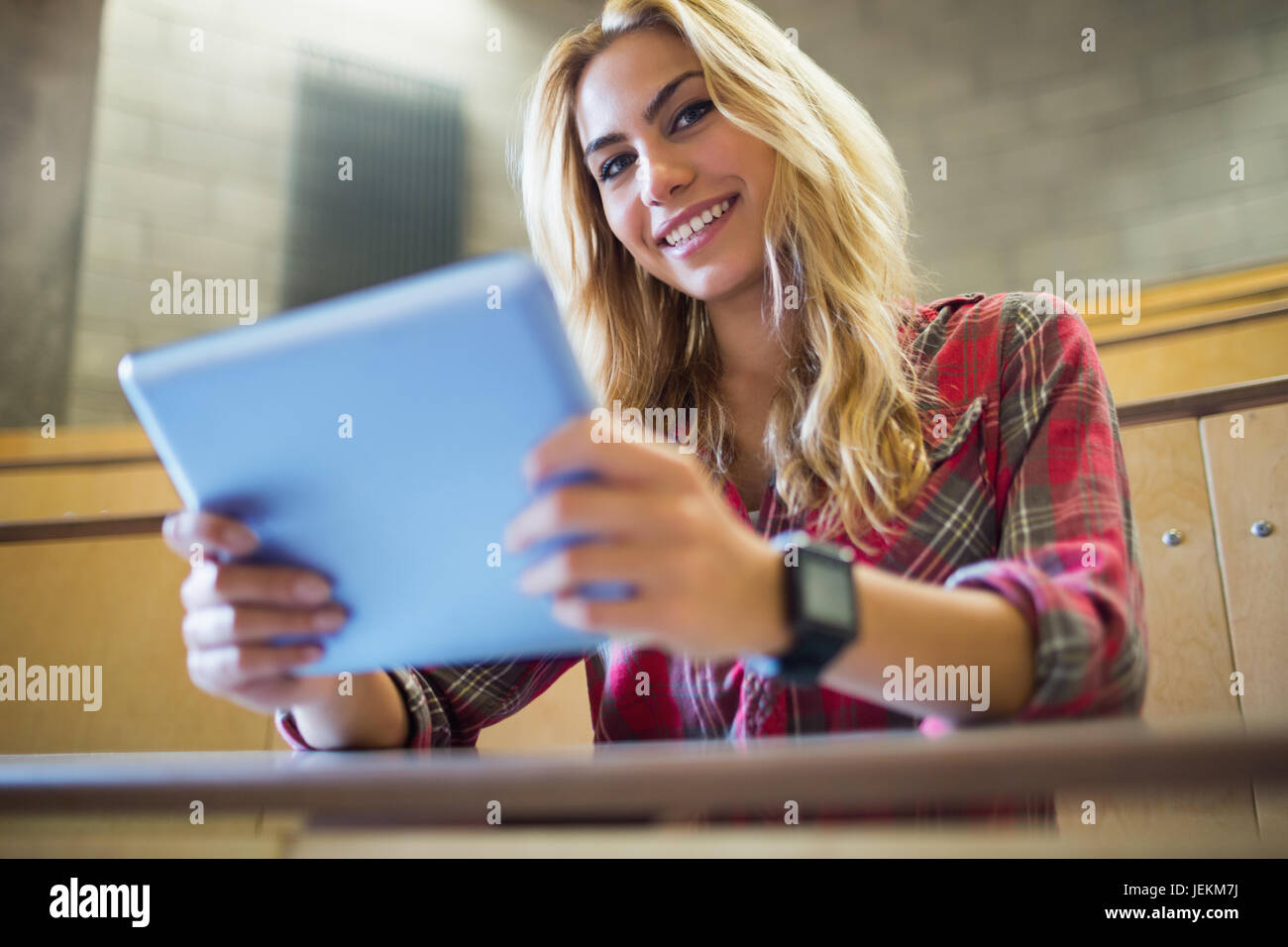 Smiling female student using tablet Stock Photo - Alamy