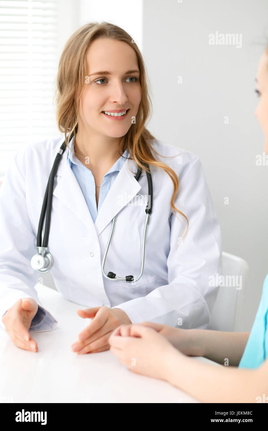 Doctor and patient sitting at the desk Stock Photo - Alamy