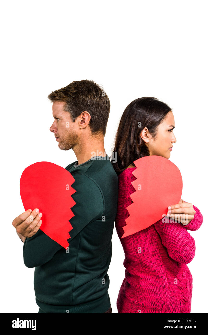 Serious couple standing back to back Stock Photo - Alamy