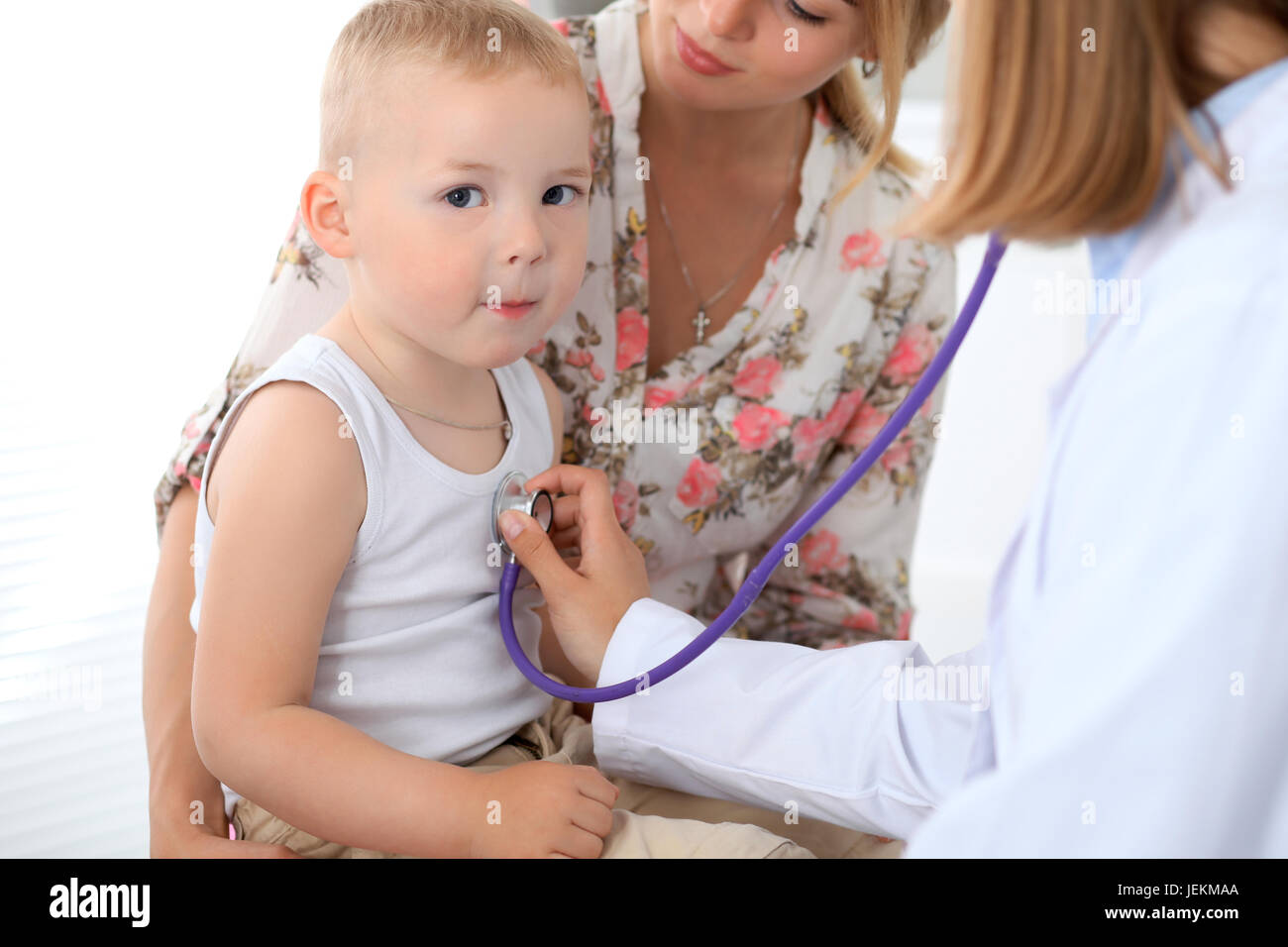 Doctor examining a child patient by stethoscope Stock Photo - Alamy