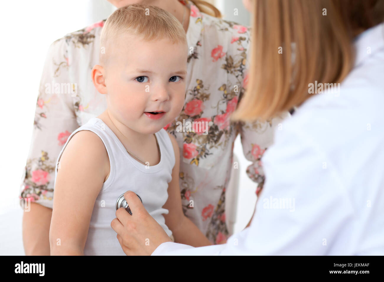 Doctor examining a child patient by stethoscope Stock Photo - Alamy