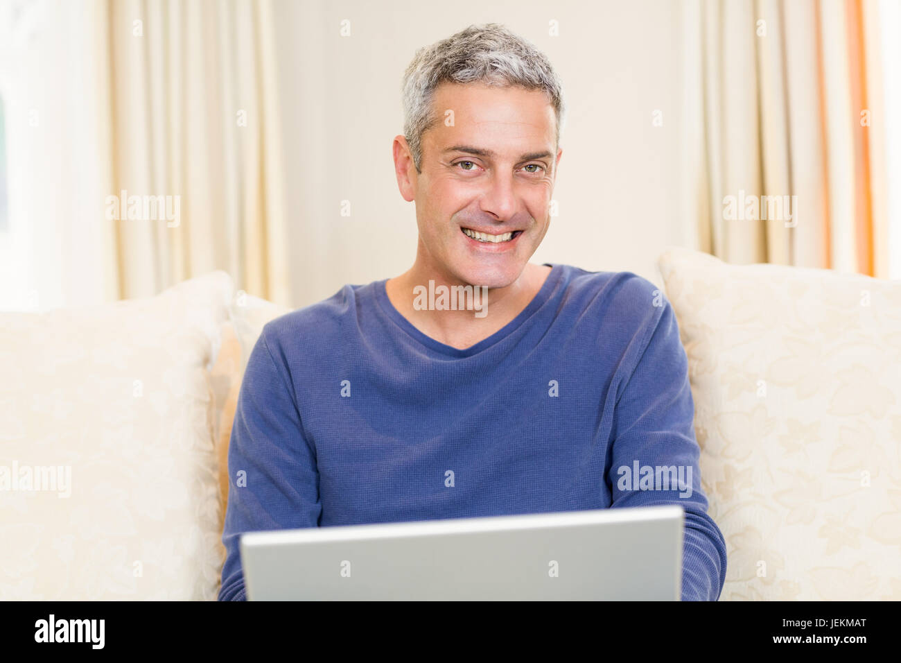 Handsome man using laptop Stock Photo - Alamy