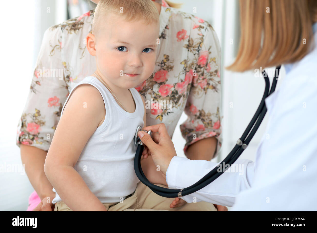 Doctor examining a child patient by stethoscope Stock Photo - Alamy