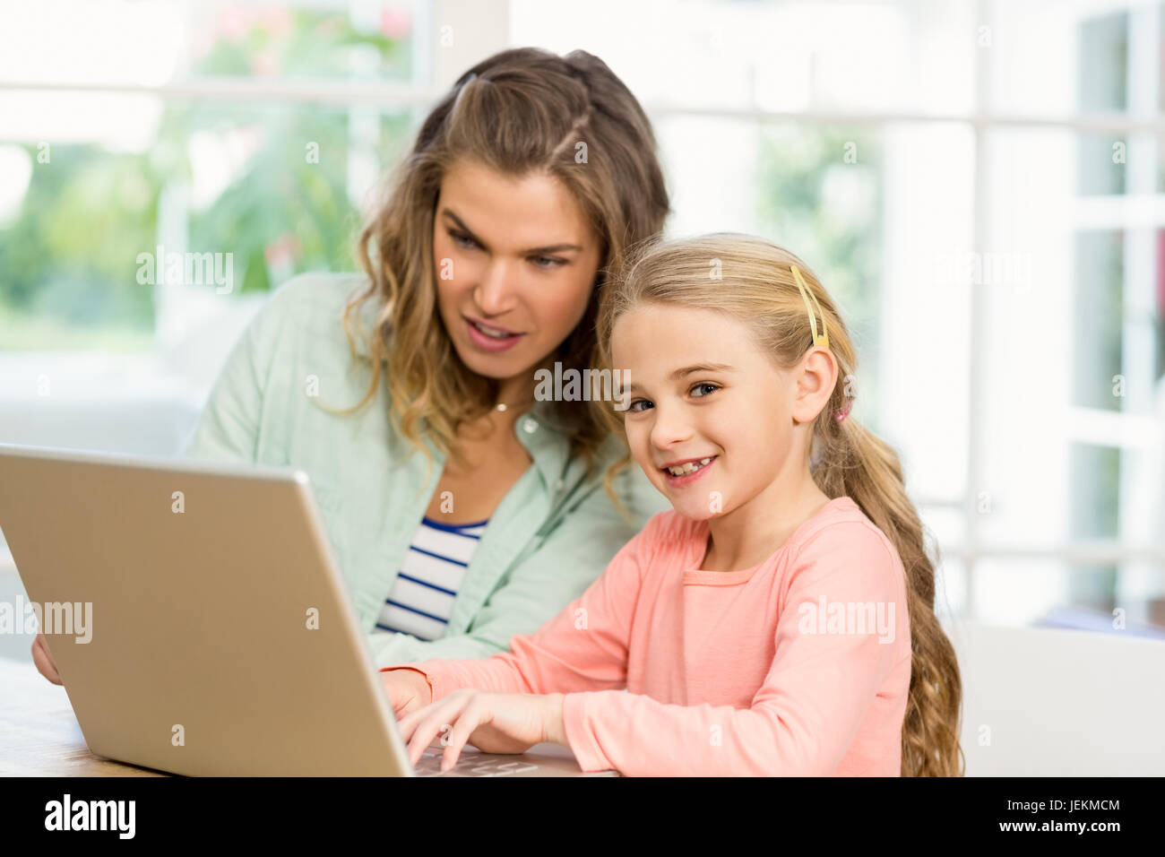 Mother and daughter using laptop Stock Photo - Alamy