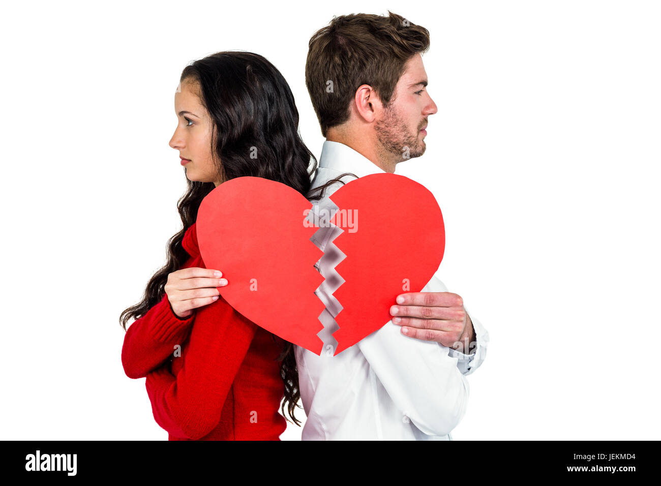 Couple back to back holding heart halves Stock Photo - Alamy