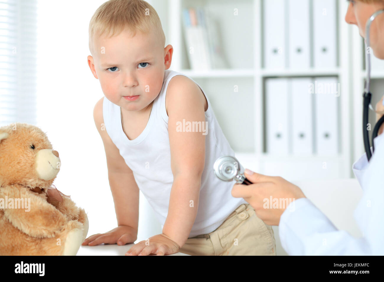 Doctor examining a child patient by stethoscope Stock Photo - Alamy