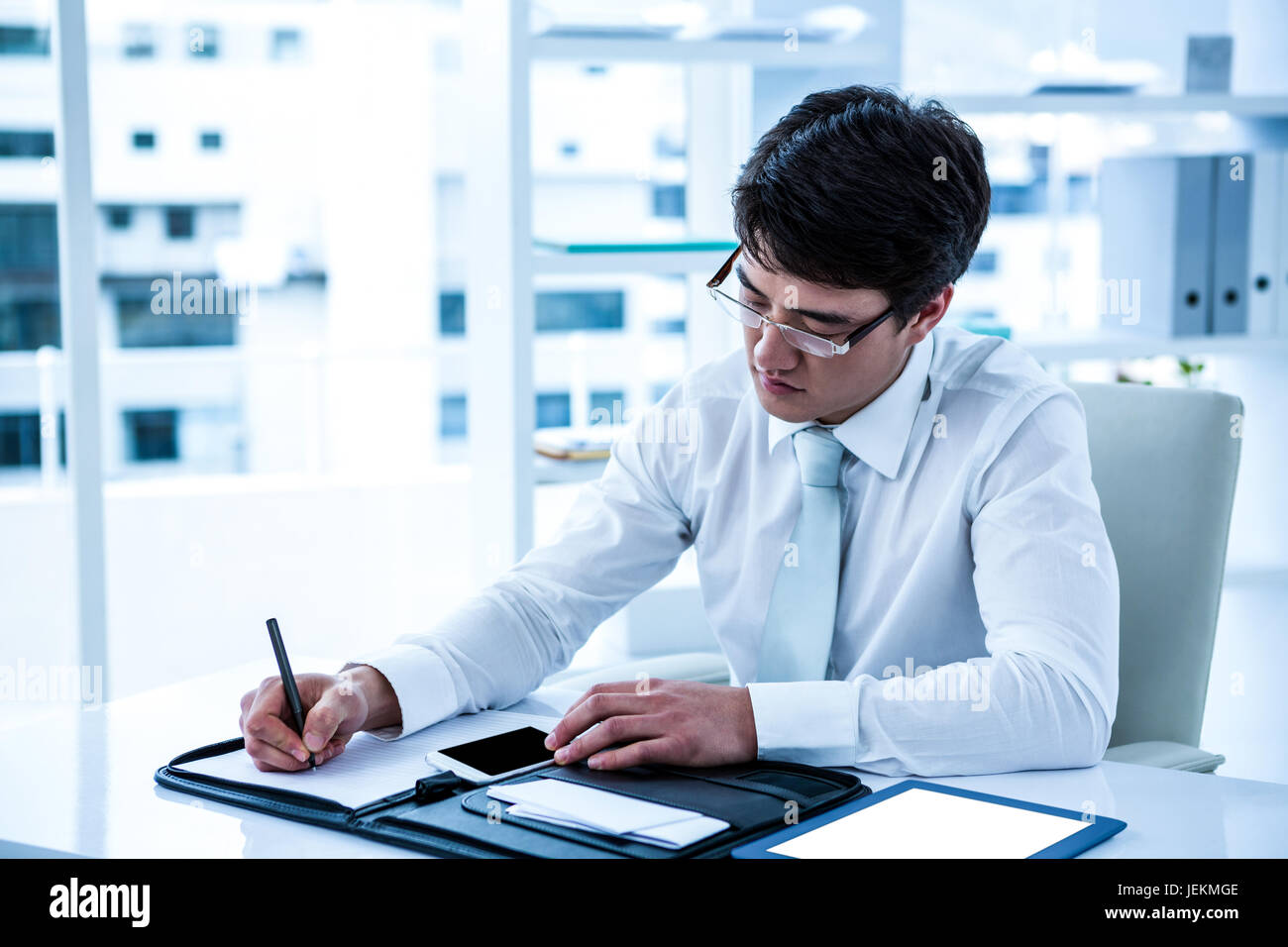 Focused asian businessman is working Stock Photo - Alamy