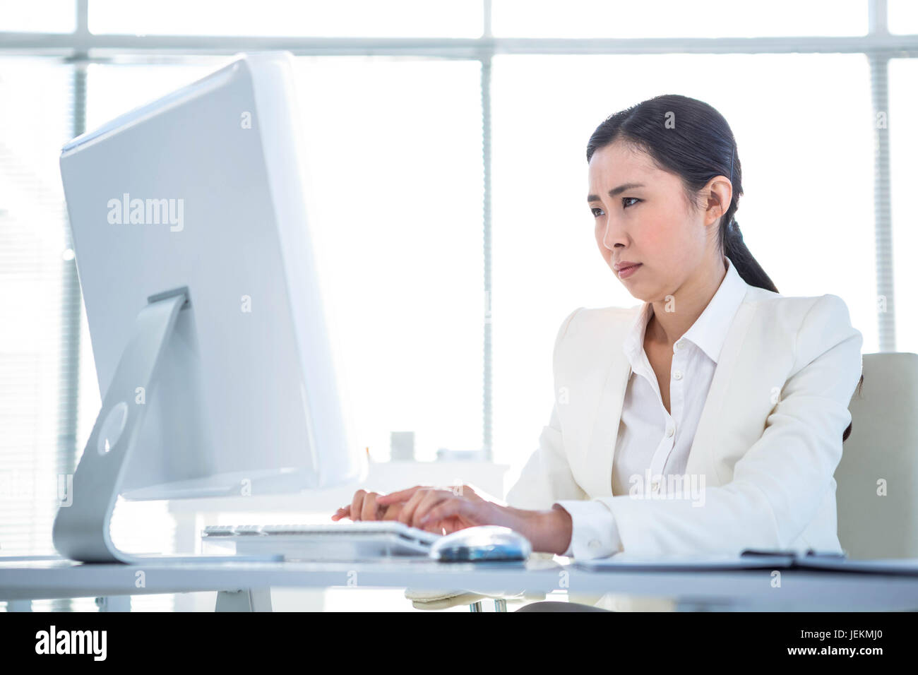 Serious businesswoman using computer Stock Photo - Alamy