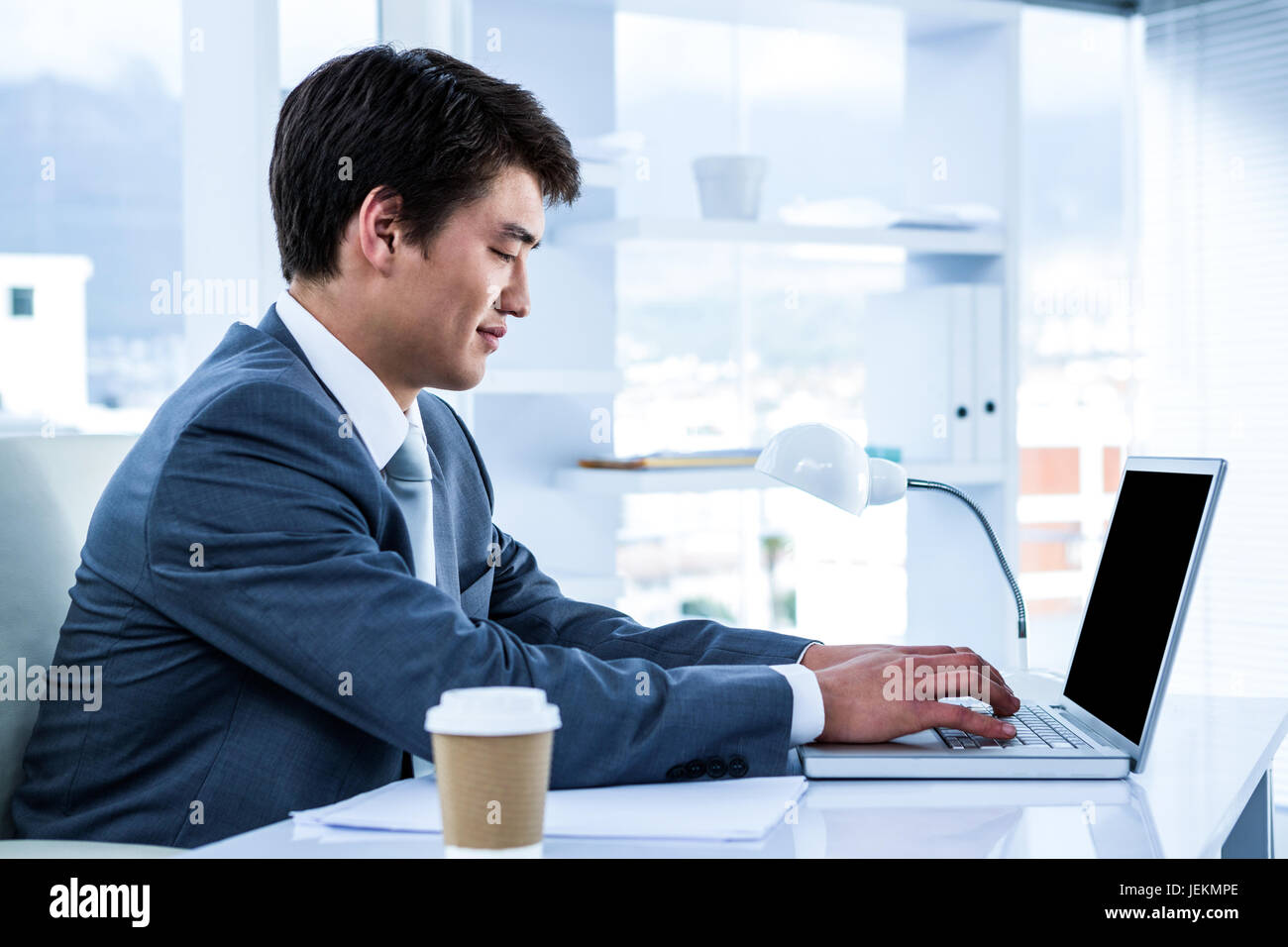 Asian businessman using his computer Stock Photo - Alamy