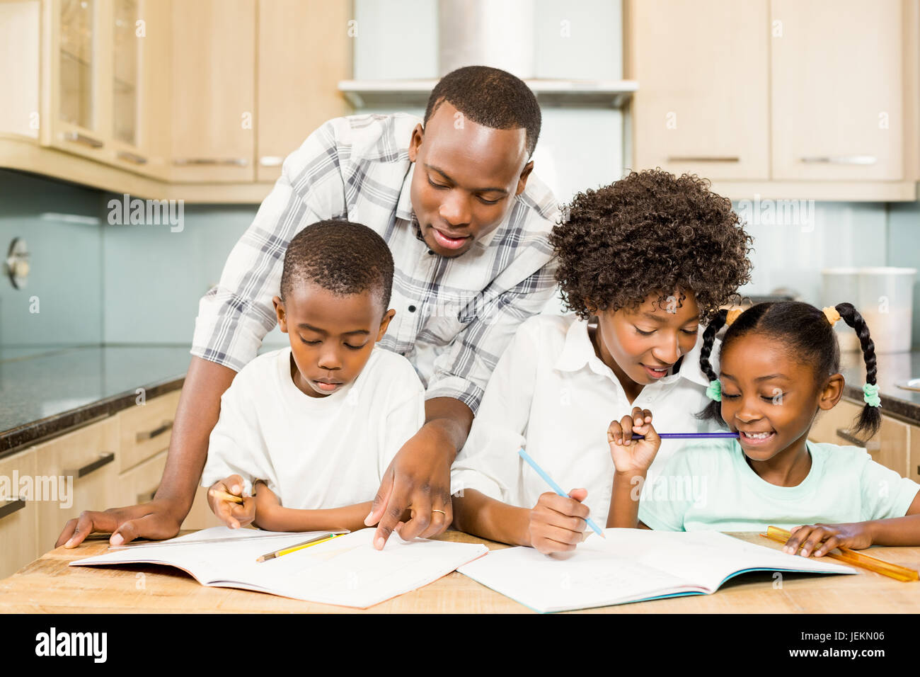 Parents checking children homework Stock Photo - Alamy