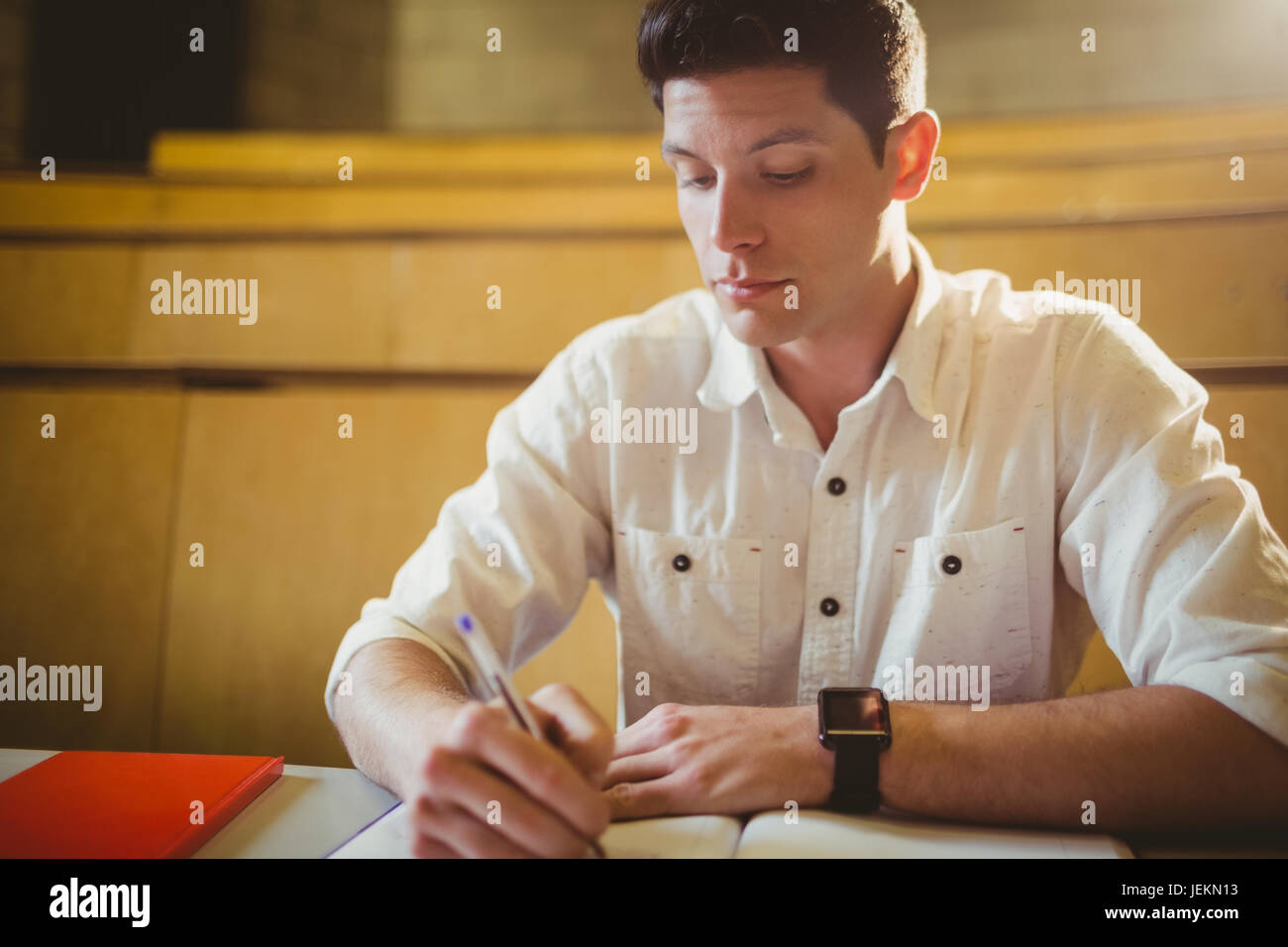 Concentrated male student during class Stock Photo - Alamy