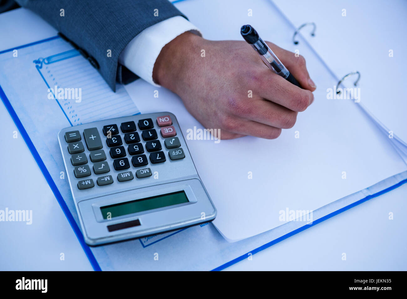Close up view of desk with hands writing Stock Photo - Alamy