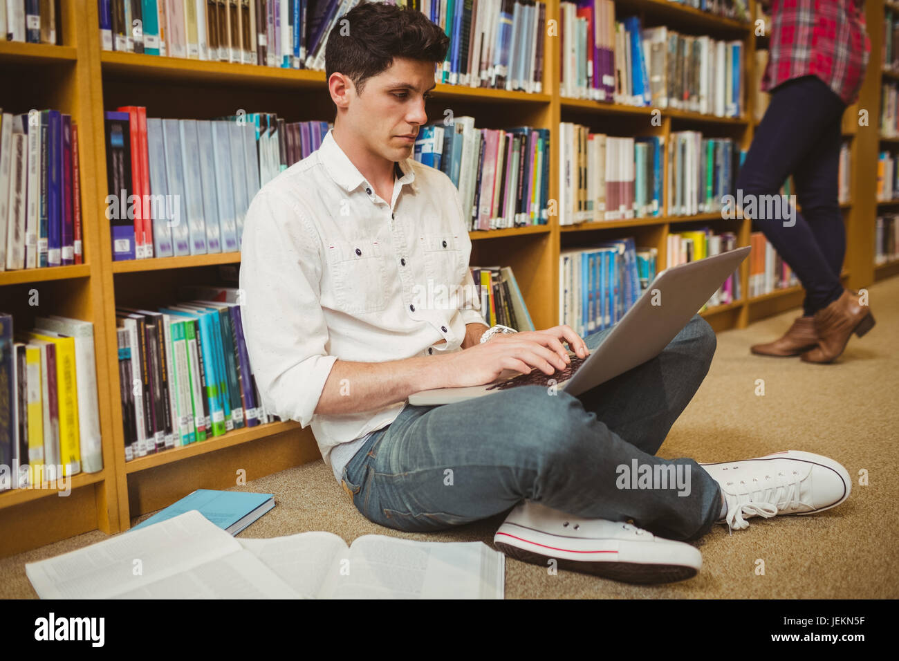 Male student working on floor Stock Photo - Alamy