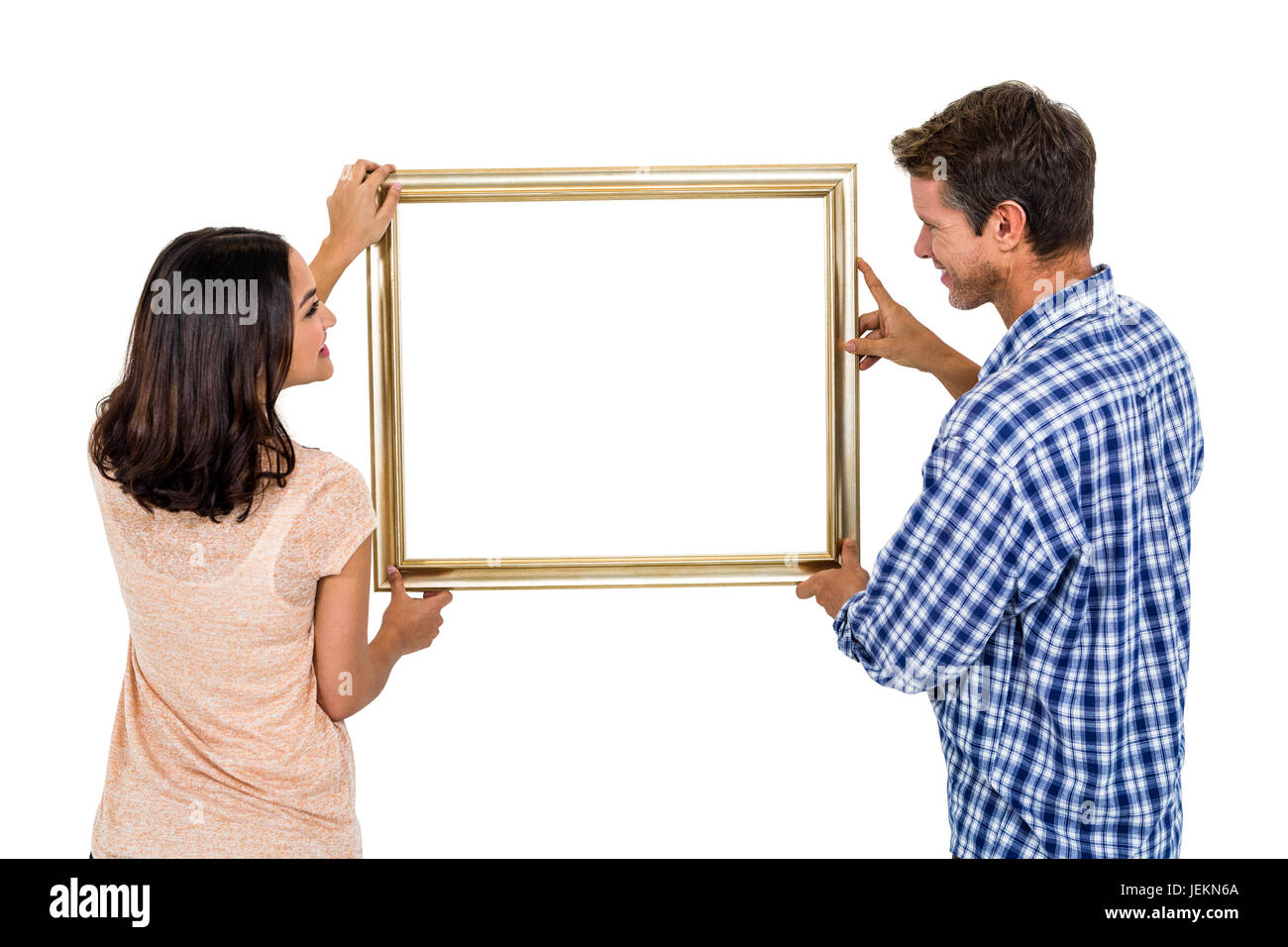 Happy couple holding picture frame Stock Photo - Alamy