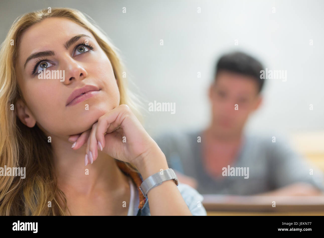 Thoughtful female student during class Stock Photo - Alamy