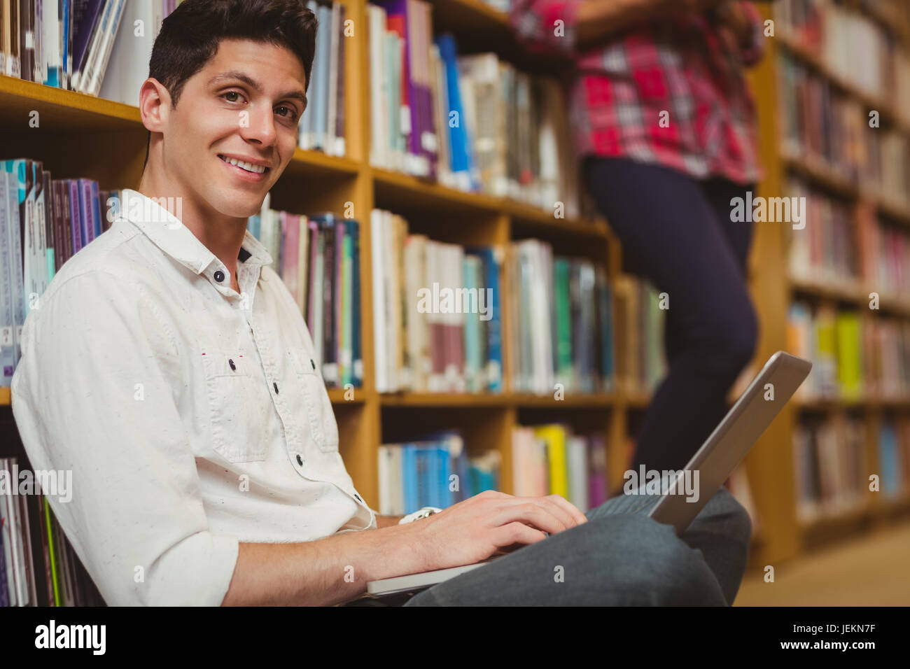 Male student working on floor Stock Photo - Alamy