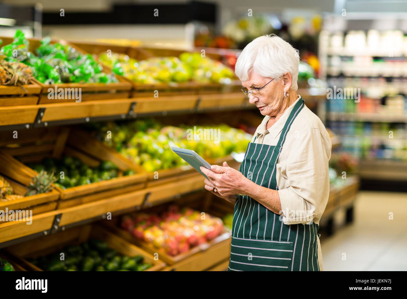 Supermarket employee using tablet hi-res stock photography and images ...