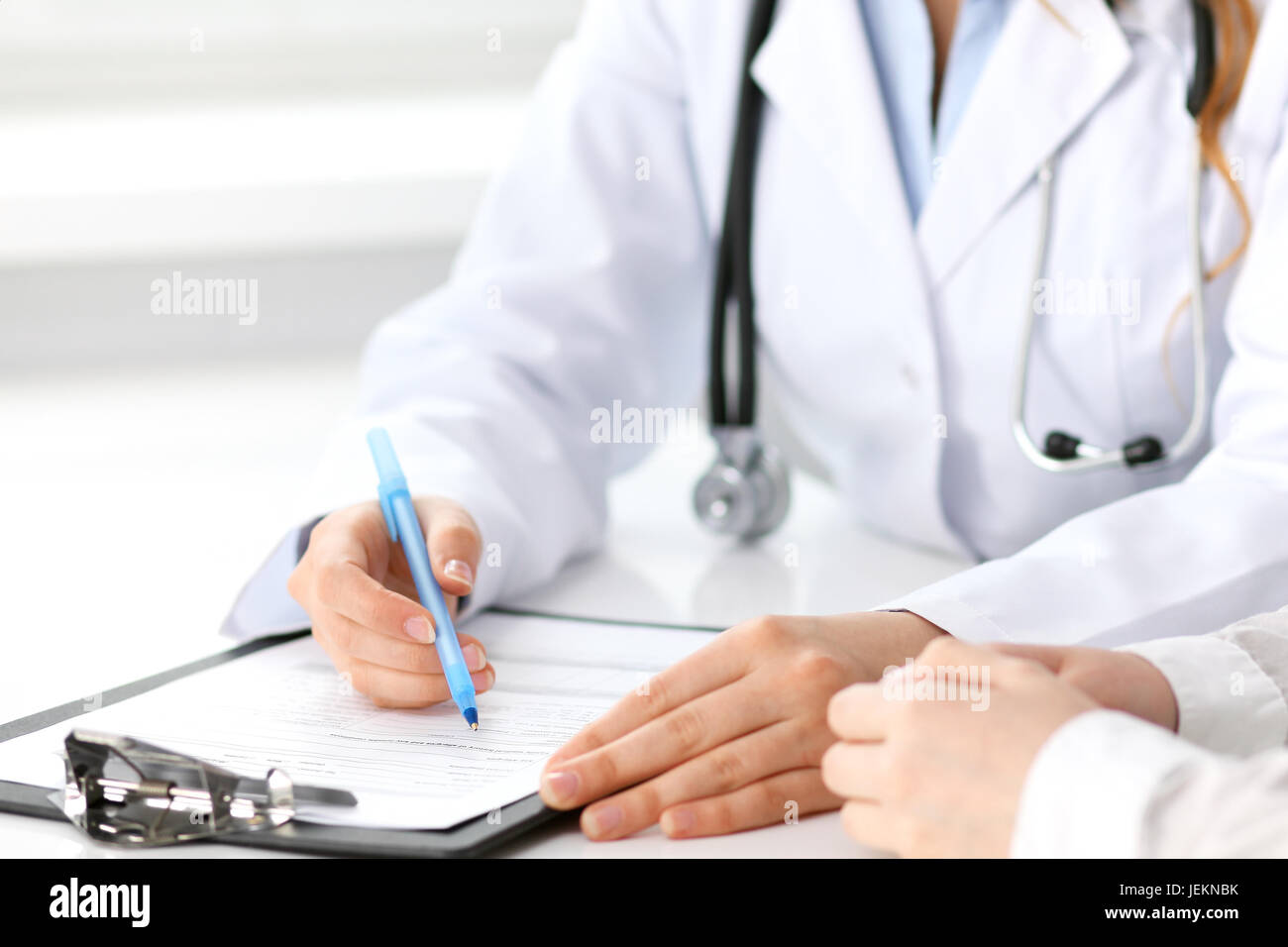 Doctor and patient sitting at the desk. Medicine and health care ...