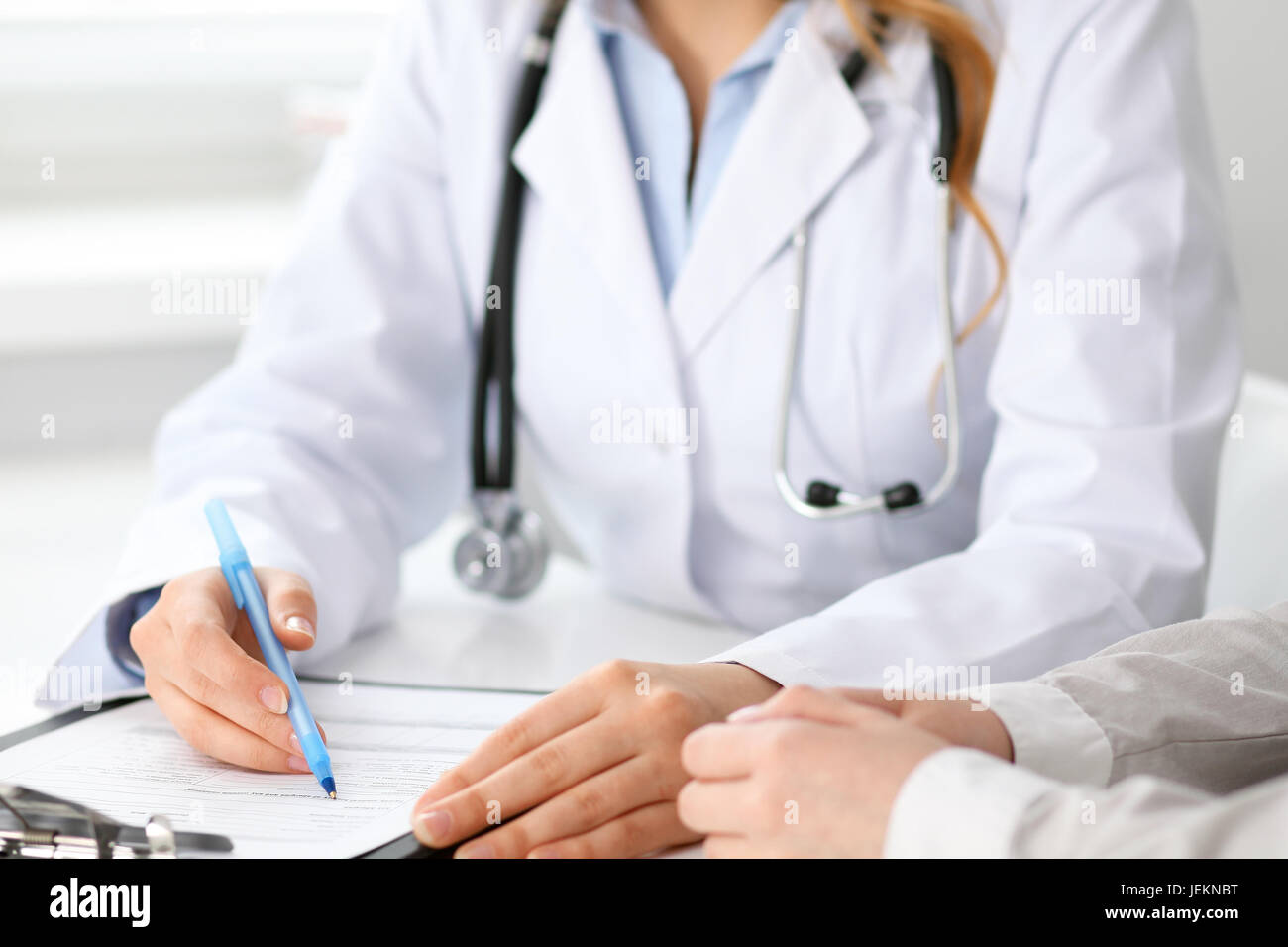 Doctor and patient sitting at the desk. Medicine and health care ...
