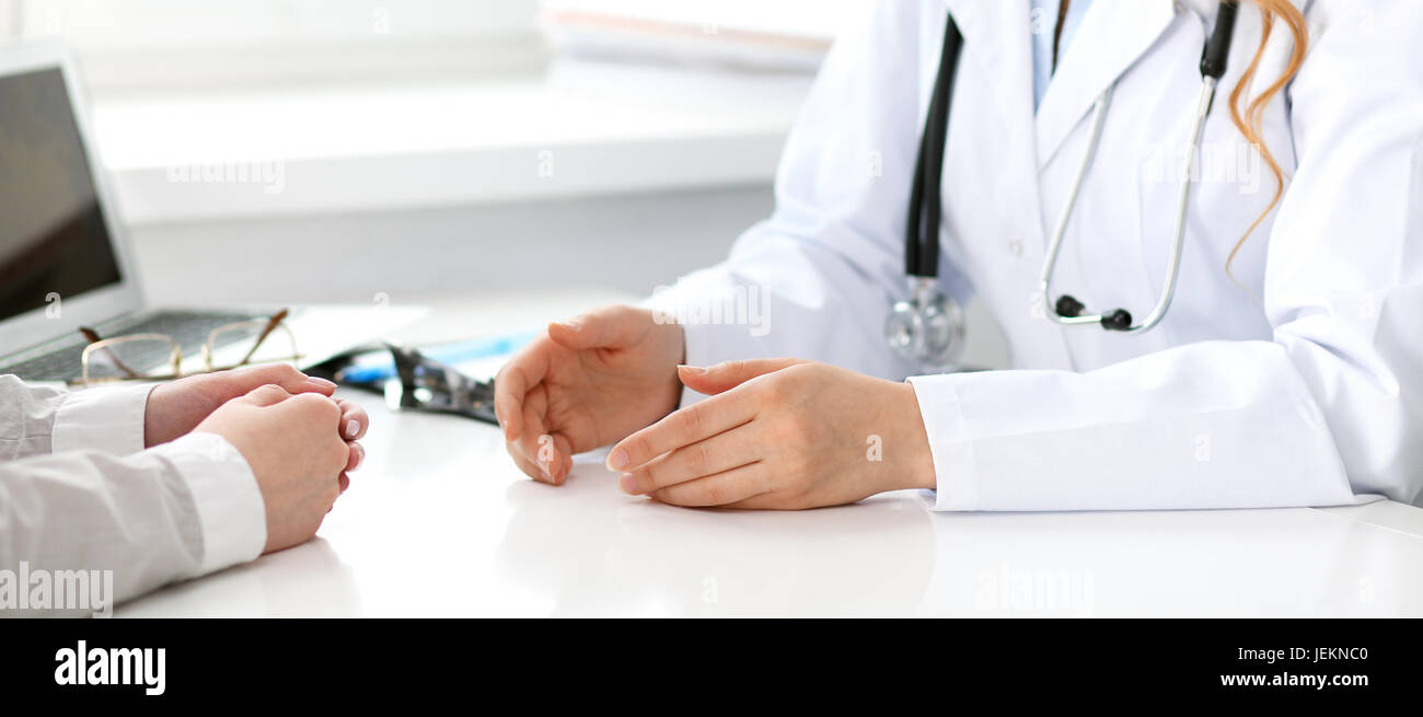 Doctor and patient sitting at the desk. Medicine and health care ...