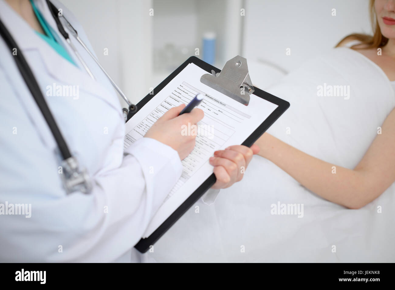 Close-up of a female doctor holding application form while consulting ...