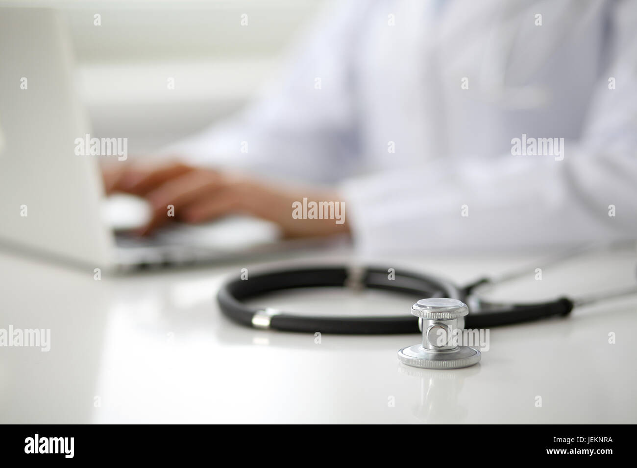 Female doctor typing on laptop, close up Stock Photo - Alamy