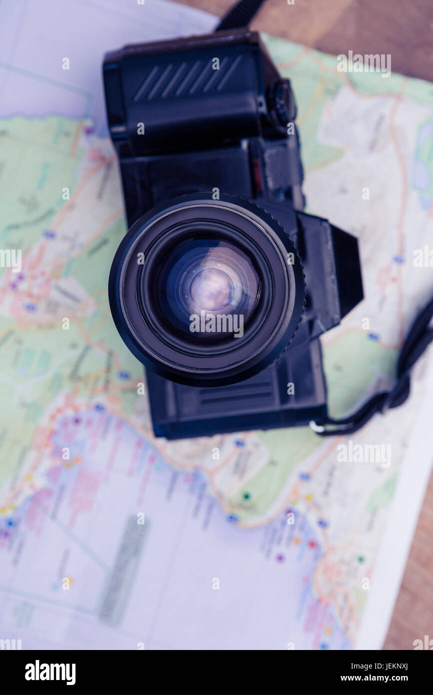 Directly above shot of camera and map Stock Photo - Alamy