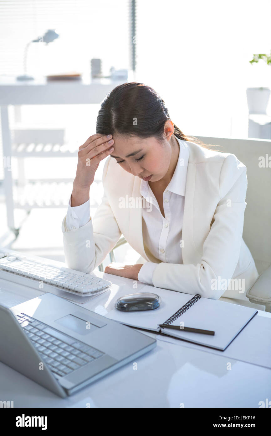 Stressed businesswoman working at her desk Stock Photo - Alamy