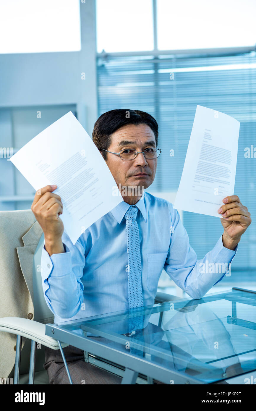 Busy businessman showing papers Stock Photo - Alamy
