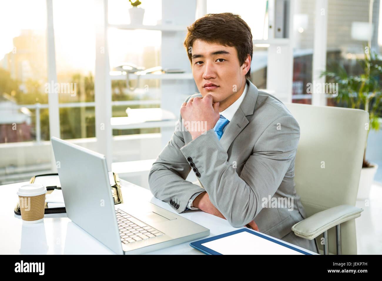 Serious Asian man sitting Stock Photo - Alamy