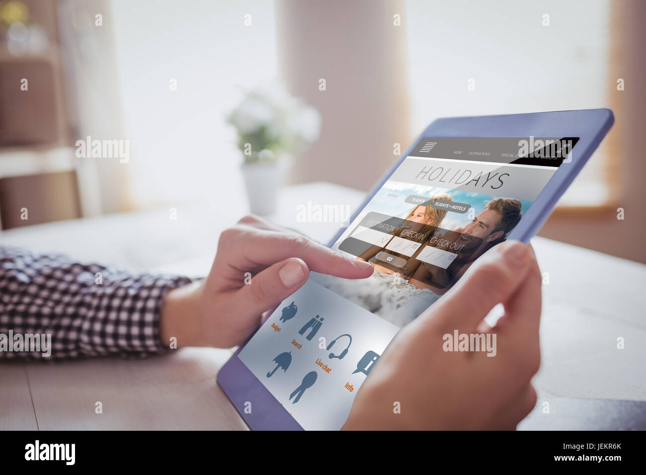 Composite image of hand using tablet Stock Photo - Alamy