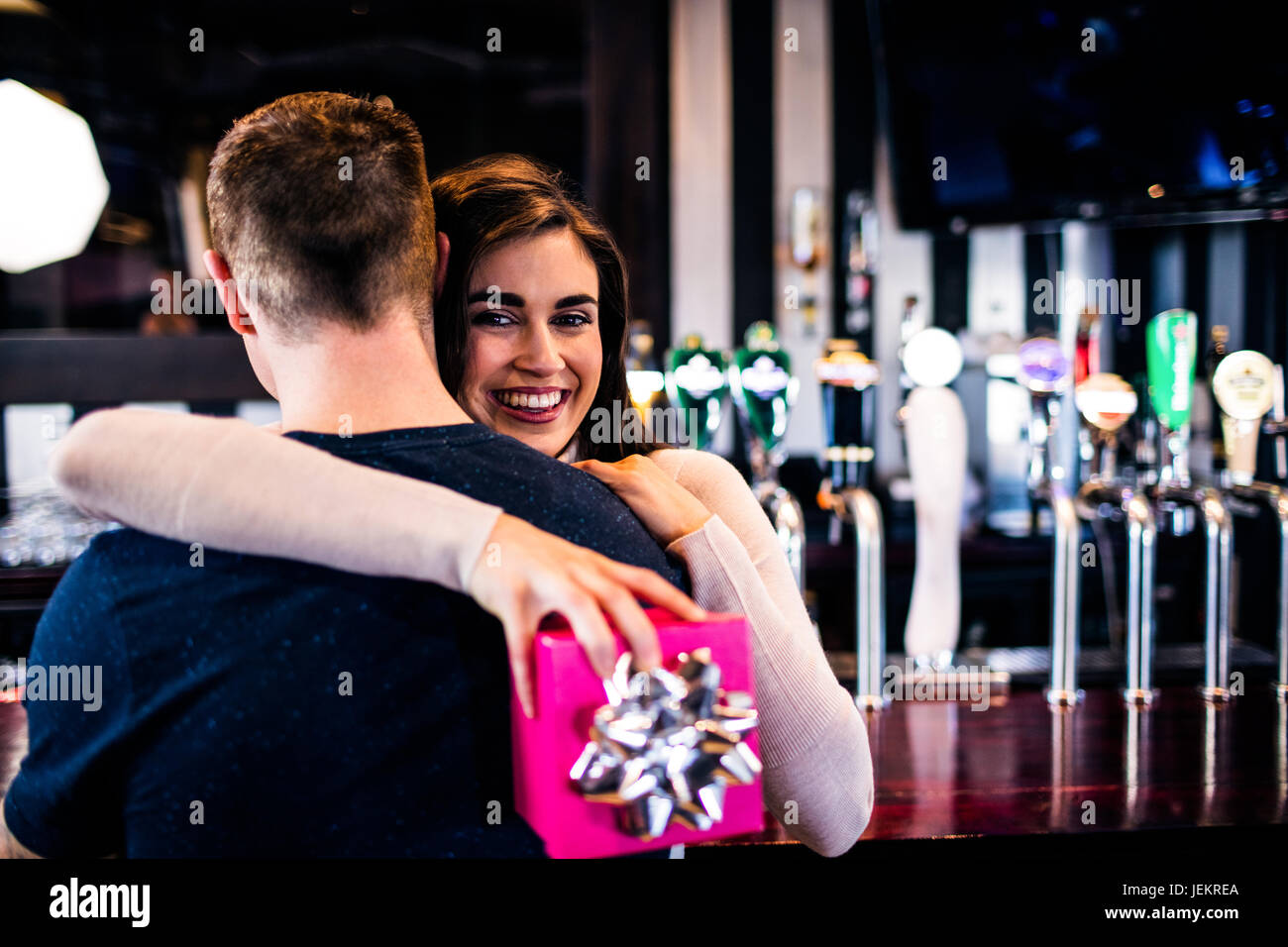 Couple hugging in a bar Stock Photo - Alamy