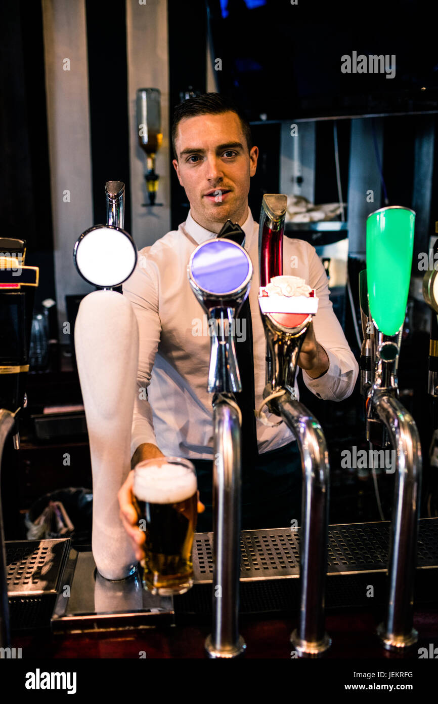Barman serving a pint of beer Stock Photo - Alamy