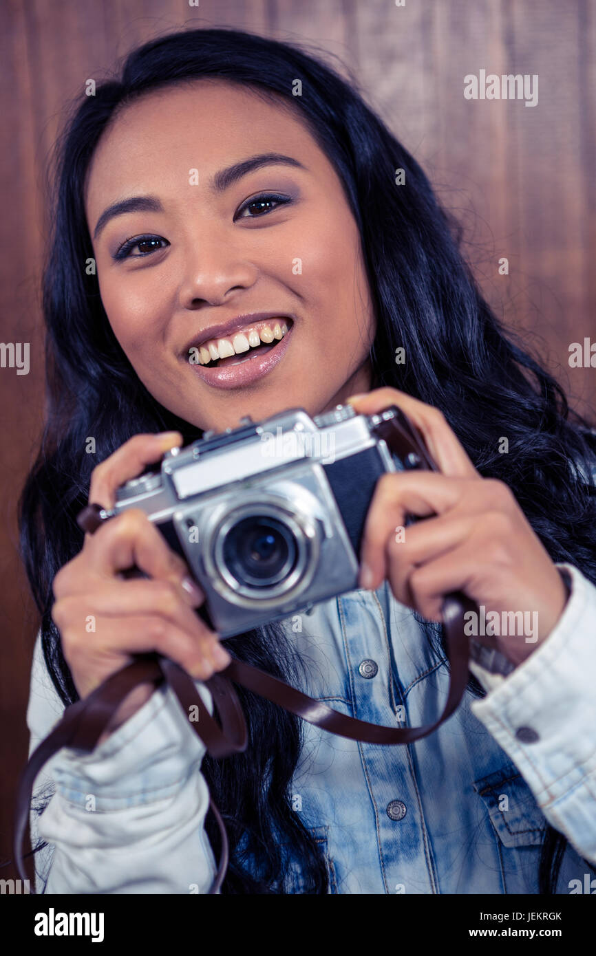 Asian woman holding digital camera Stock Photo - Alamy