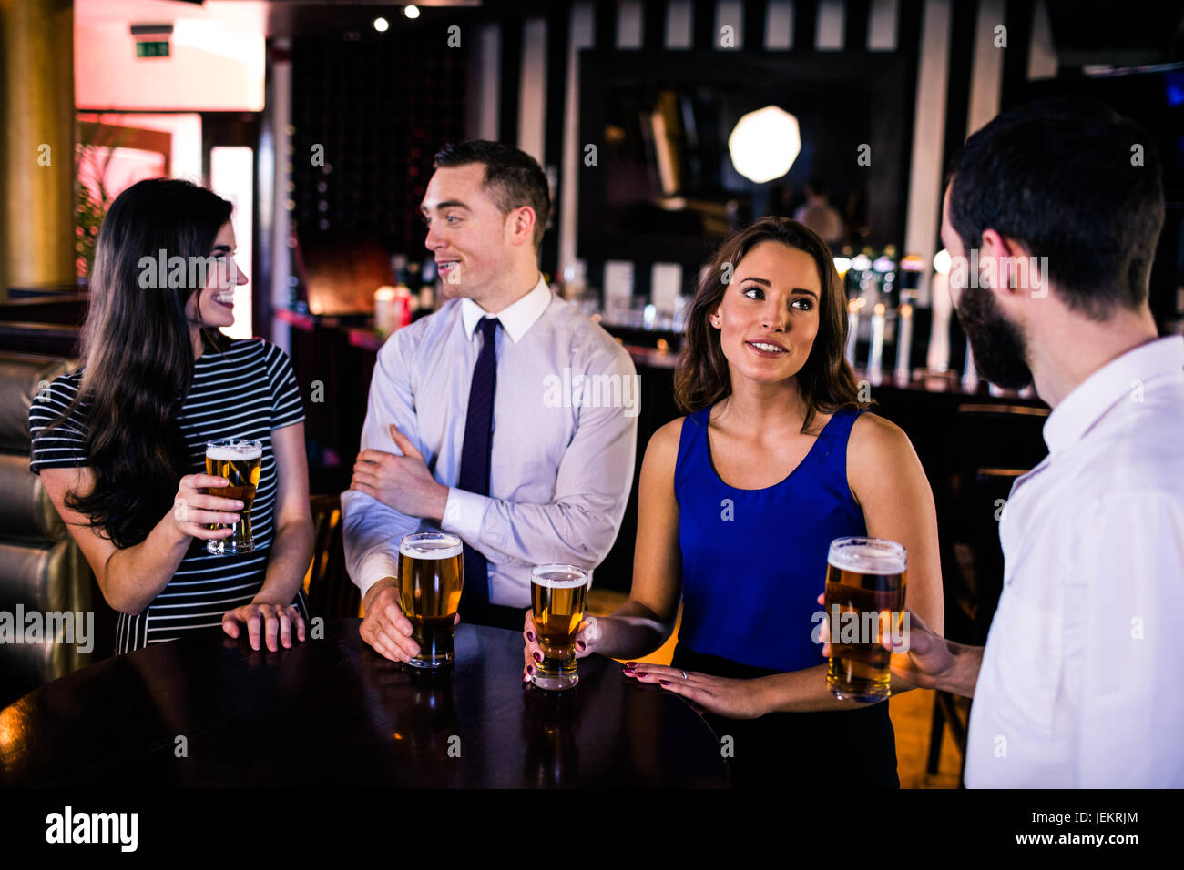 Friends talking and having a beer Stock Photo - Alamy