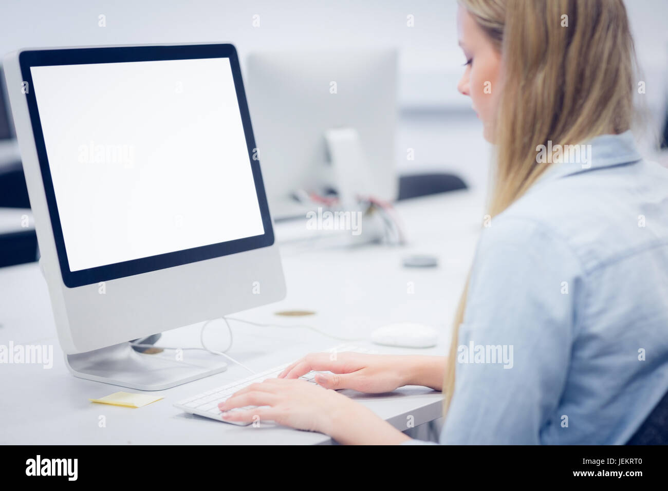 Rear view of student using computer Stock Photo - Alamy