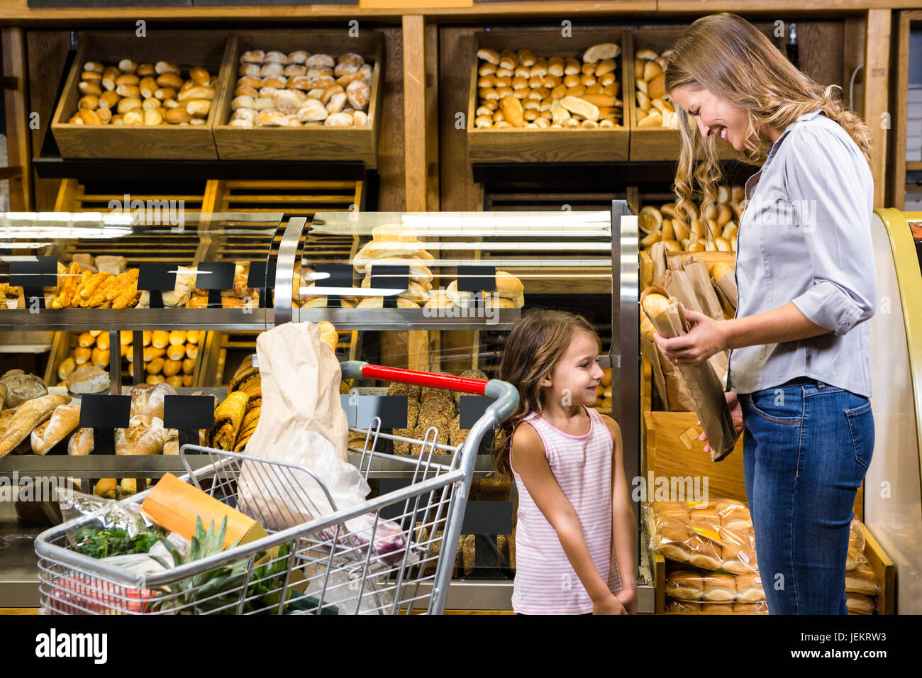 Mother and daughter taking bread Stock Photo - Alamy