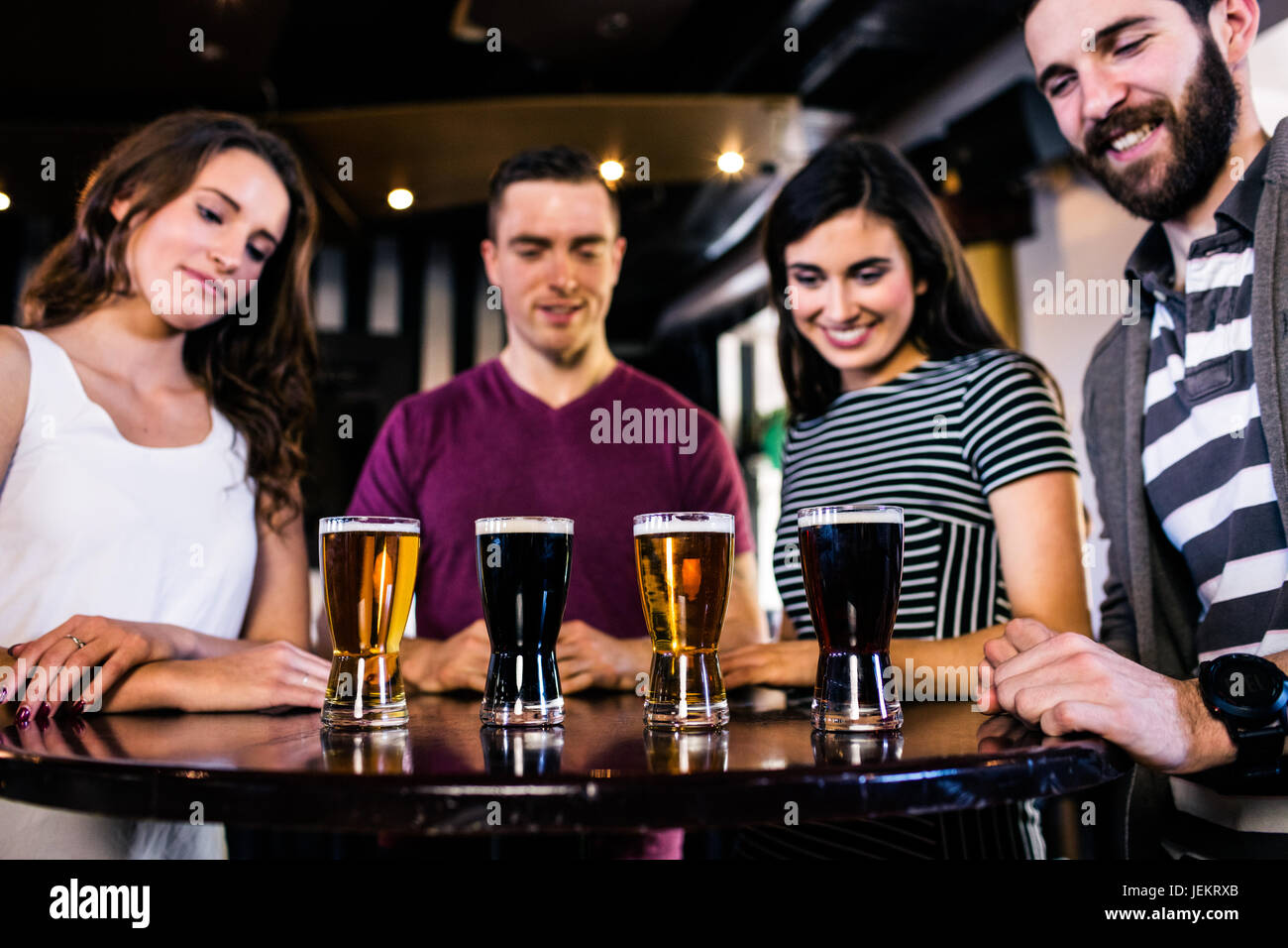 Friends interacting having beer counter hi-res stock photography and ...