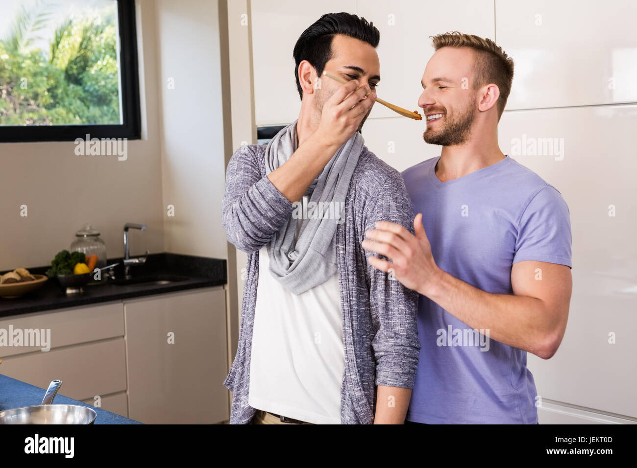 Smiling man tasting food Stock Photo - Alamy