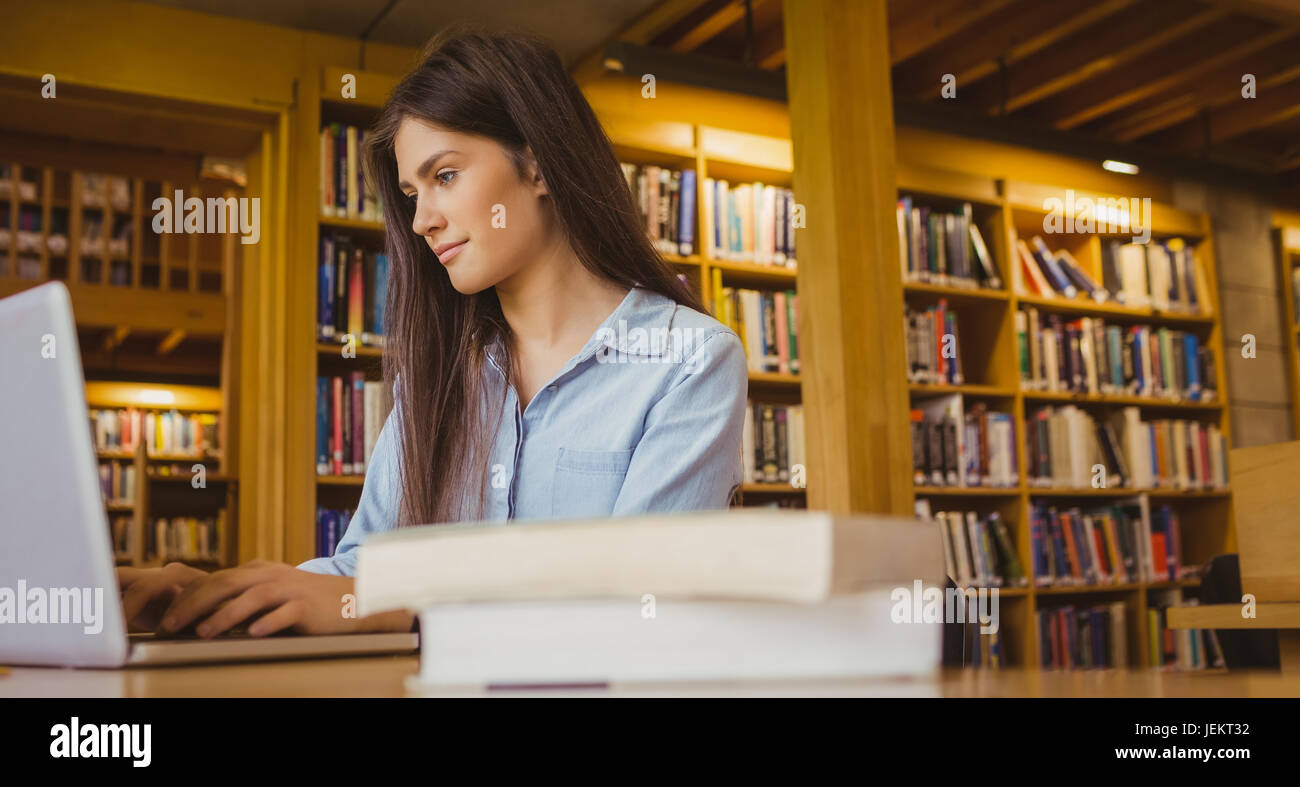 Smiling student working on laptop Stock Photo - Alamy