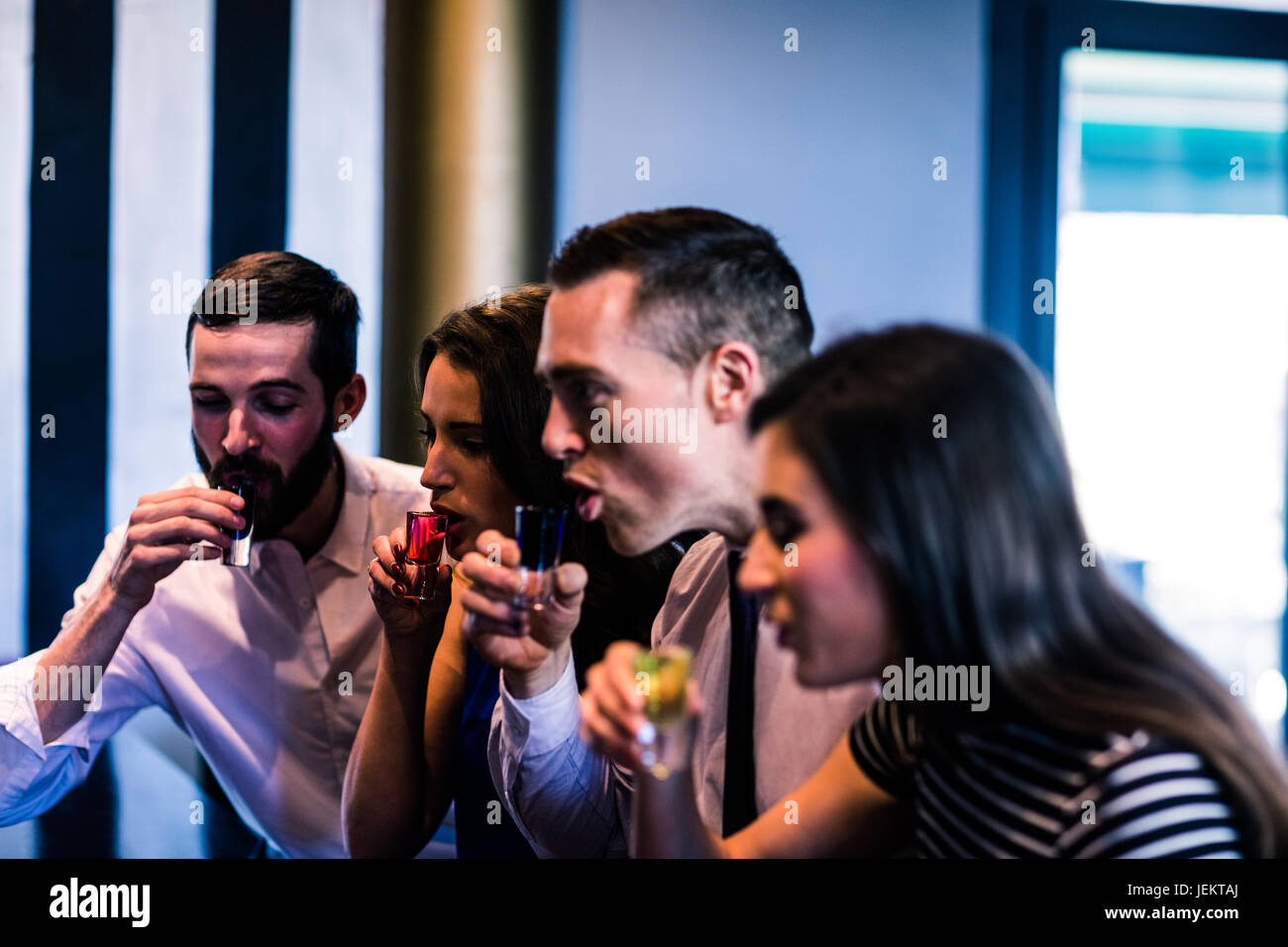 Friends drinking alcohol shots Stock Photo - Alamy