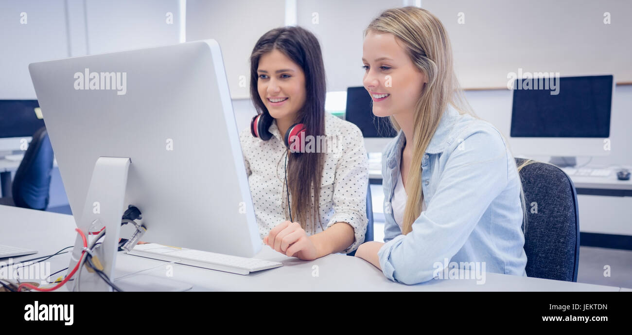 Smiling students using computer Stock Photo - Alamy