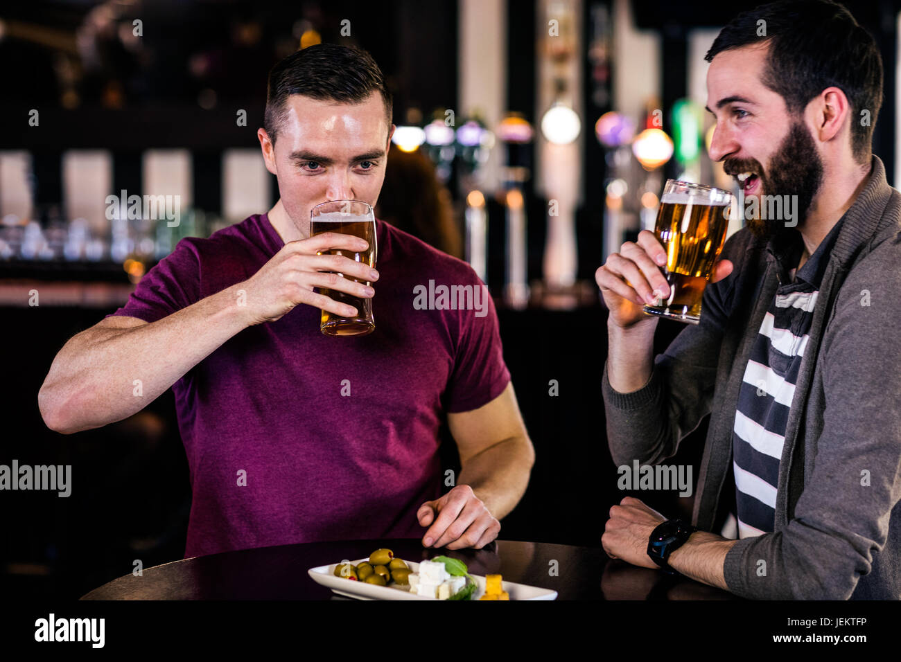 Friends having a pint Stock Photo - Alamy