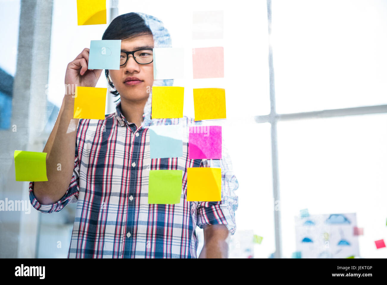 Creative businessman writing on sticky notes Stock Photo - Alamy